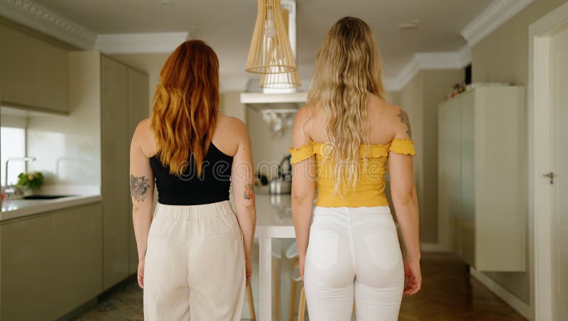 Two Women Standing Together on Back View at Home Stock Photo - Image of young, friends: 250268506
