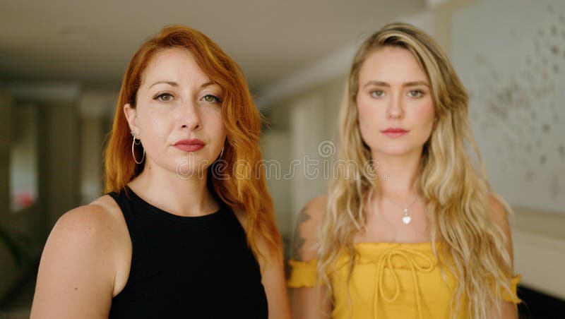 Two Women Standing Together with Serious Expression at Home Stock Photo ... Two Women Standing Together with Serious Expression at Home Stock Photo ...