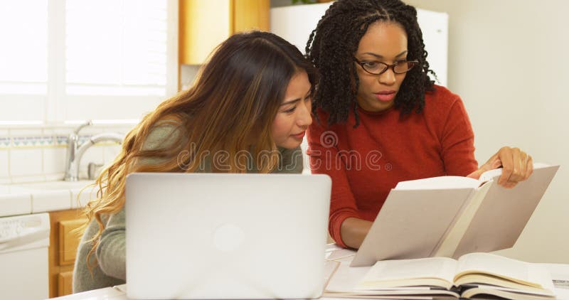 Two Women Students Studying in Kitchen with Laptop Computer Stock Photo ...