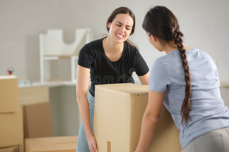 Two Women Suffering Lifting Box Moving Home Stock Image - Image of ...