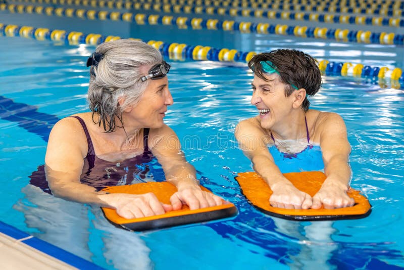 Two Women Swimming with the Floats and Looking Happy Stock Image ...