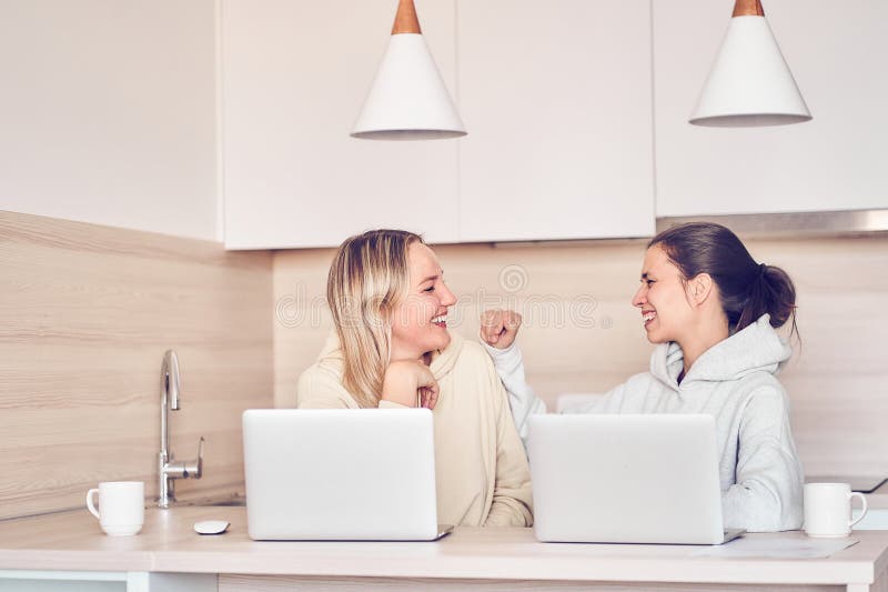 Two Women Talk and Laugh, Look at Each Other, Discuss an Online ...