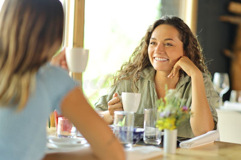 Two Women Talking Drinking Coffee in a Restaurant Stock Image - Image ...