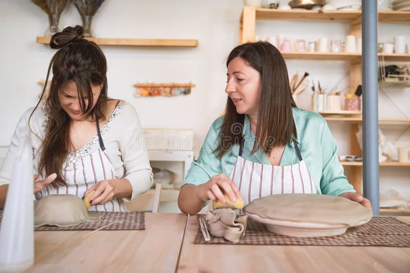 Two Women Talking while Making Clay Crafts in Pottery Class. Stock ...