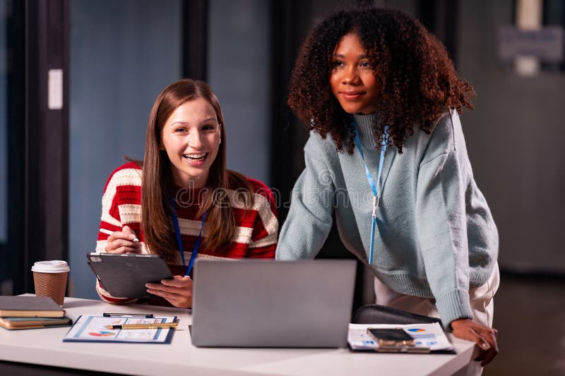 Two Women with Teamwork Laptop and Research for Articles ...
