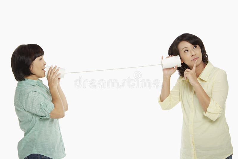 Two women using cup phone stock image. Image of disposable - 185438911