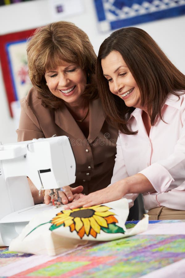 Two Women Using Electric Sewing Machine Stock Photo - Image of textile ...