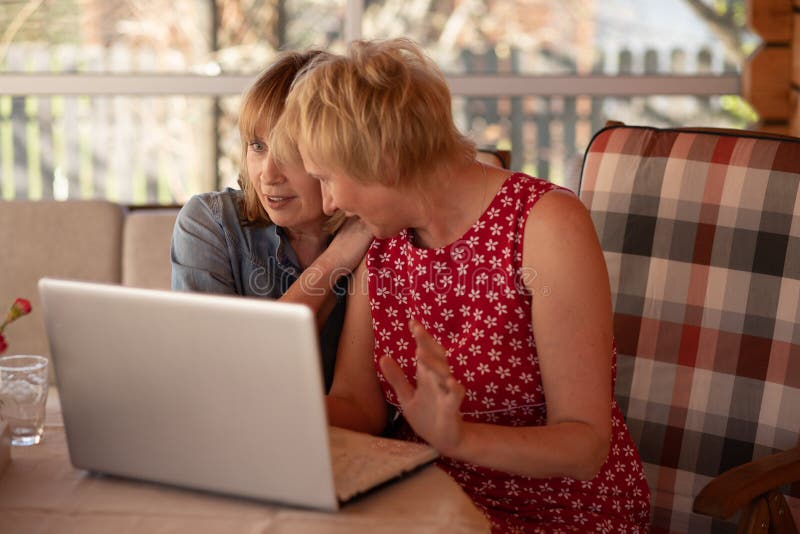 Two Women Using Laptop Computer in Coffee Shop Stock Image - Image of ...