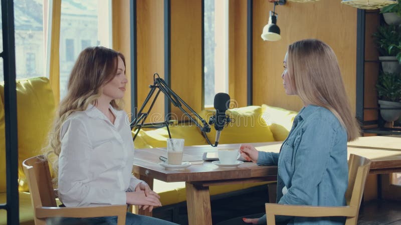 Two Women Using Microphone during Interview at Cozy Cafe Stock Footage ...