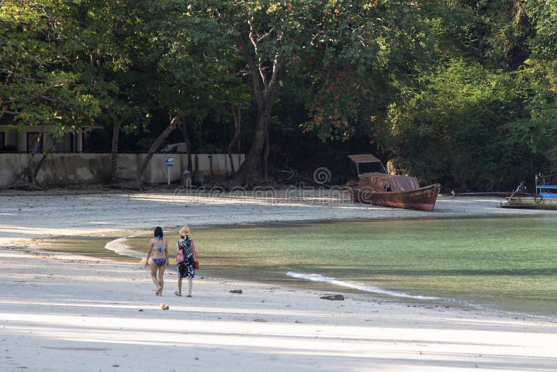 Two Women Walk Along the Sandy Beach in the Morning Stock Photo - Image ...