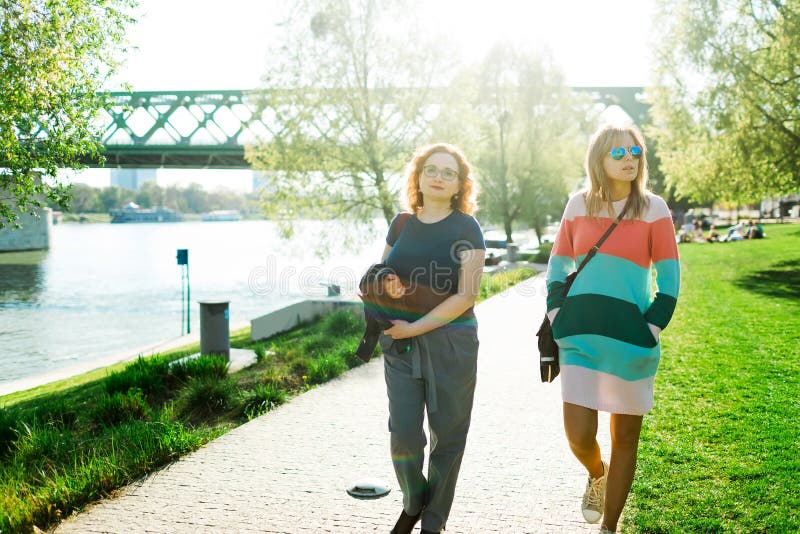 Two Women Walking Along the Waterfront Stock Photo - Image of walk ...