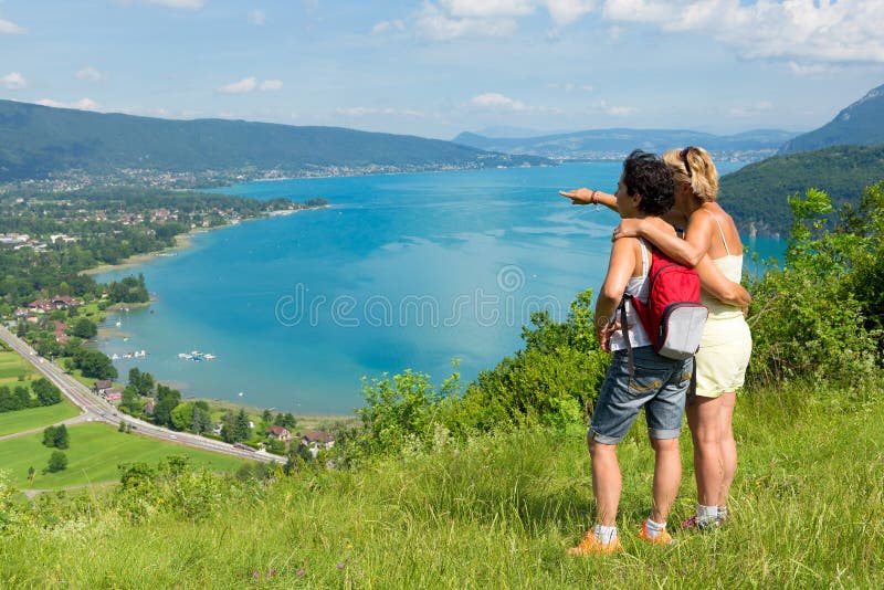 Two Women Watching View of Lake Annecy Stock Image - Image of clouds ...