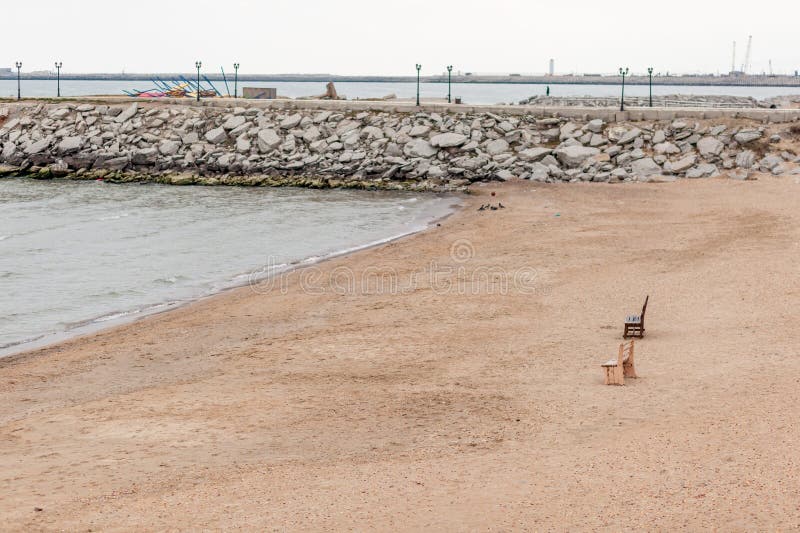 Two Wooden Benches Stand on the Beach with Sand. Stock Image - Image of ...