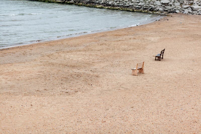 Two Wooden Benches Stand on the Beach with Sand. Stock Photo - Image of ...