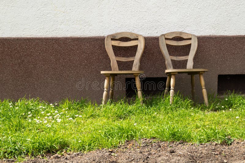 Wooden Chairs in Front of a House Wall Stock Photo - Image of wall ...