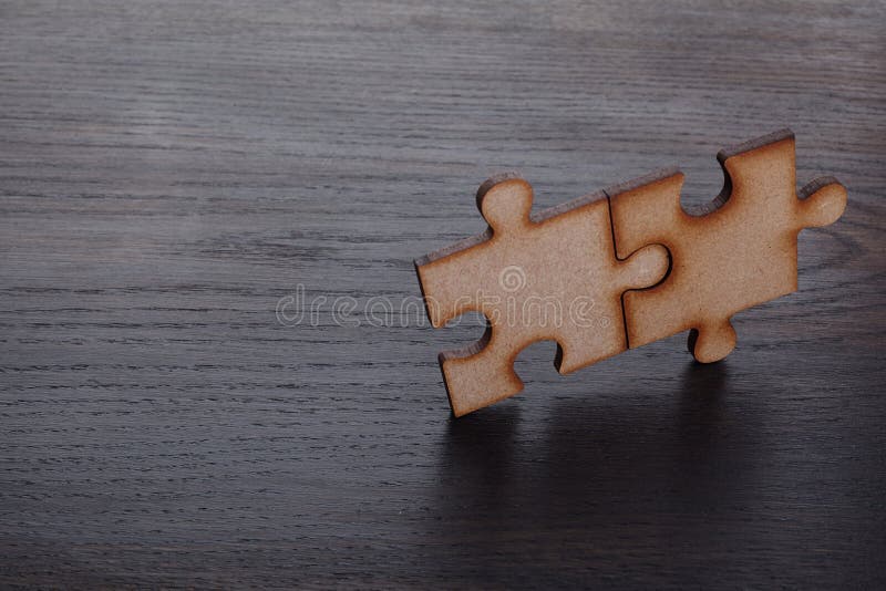 Two Wooden Pieces of Jigsaw Puzzle on Wooden Background Stock Image ...