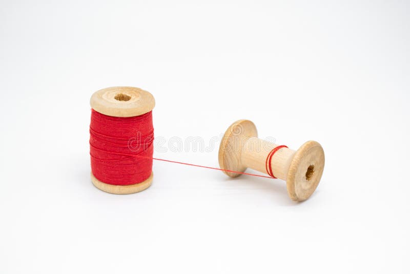 Two Wooden Spools of Thread. One is Full, the Other almost Empty ...