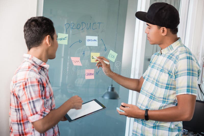 Two Worker Correcting a Word on Paper Notes To Make Material Discuss on ...