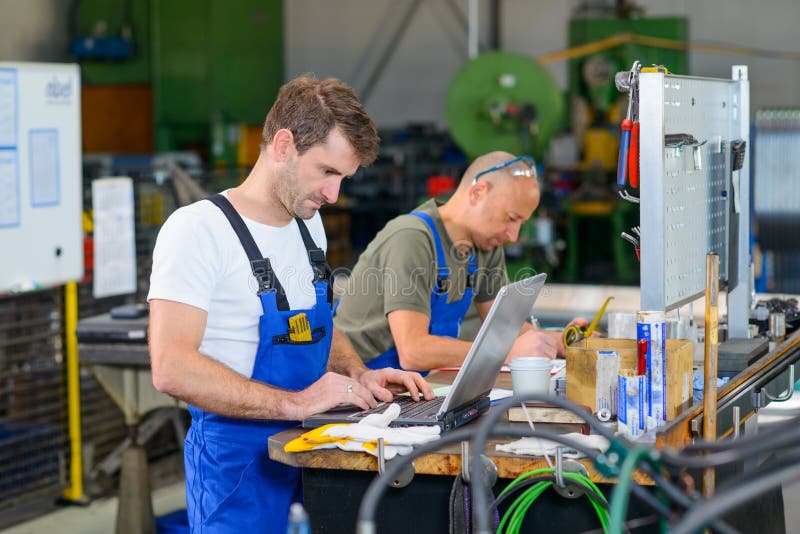 Two worker in factory stock image. Image of male, improvement - 84527977