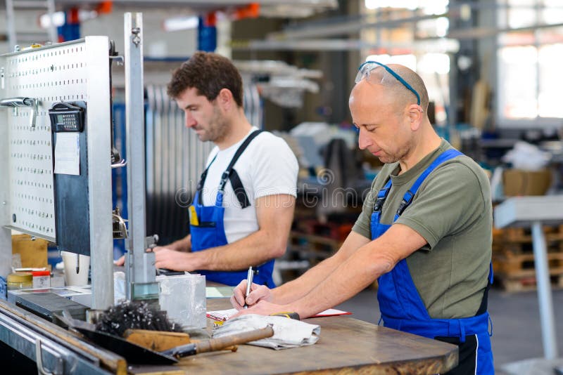 Two worker in factory stock image. Image of metal, manufacturing - 84528655