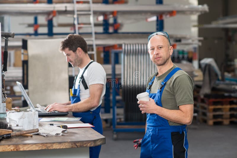 Two worker in factory stock photo. Image of middle, manufacturing ...