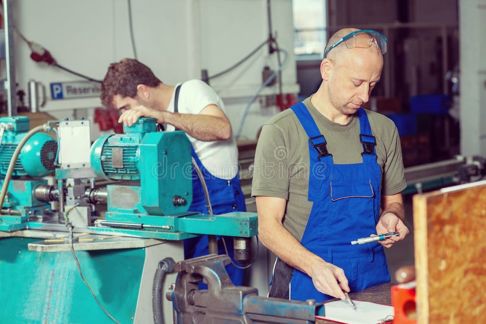 Two worker in factory stock image. Image of cheerful - 124588761