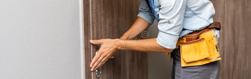 Two Worker Hands of Carpenter at Lock Installation into Wood Door Stock ...