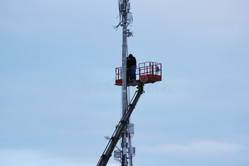 Two Workers Assemble Equipment for Telecommunications on the Tower with ...