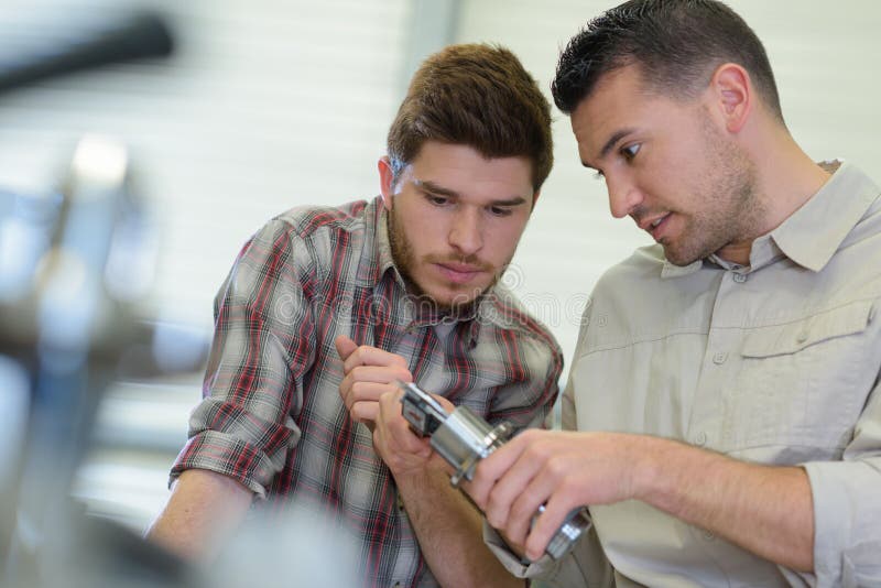 Two Workers Assembling Metal Components Stock Photo - Image of roll ...