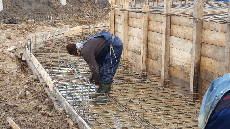 Two Workers are Building a Frame of Rebar for Pouring Concrete. Stock ...