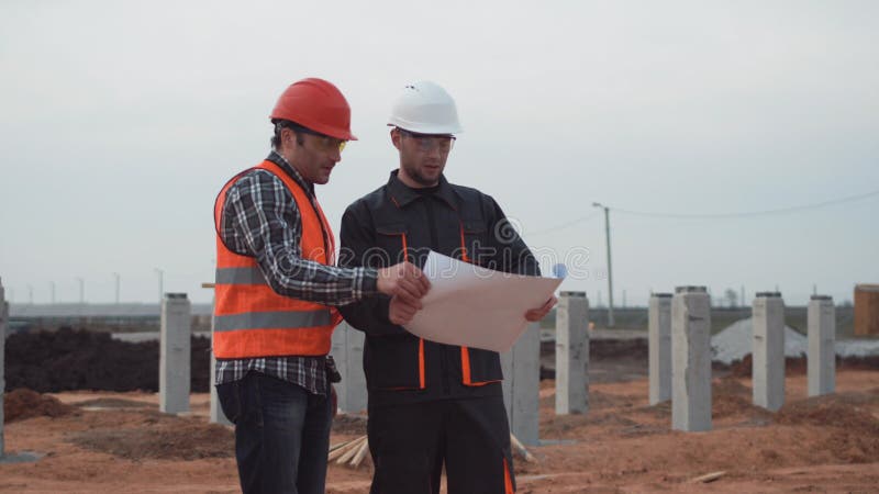 Men on Building Site Discussing the Blueprint Stock Image - Image of ...