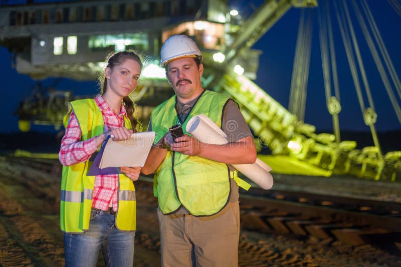 Two Workers Check Documents on Background of Stock Image - Image of ...
