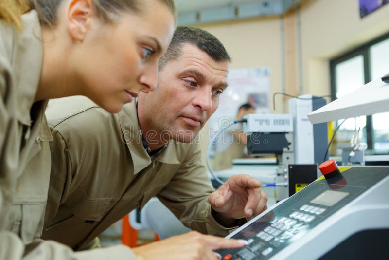 Two Workers Checking Industrial Machinery Stock Image - Image of device ...