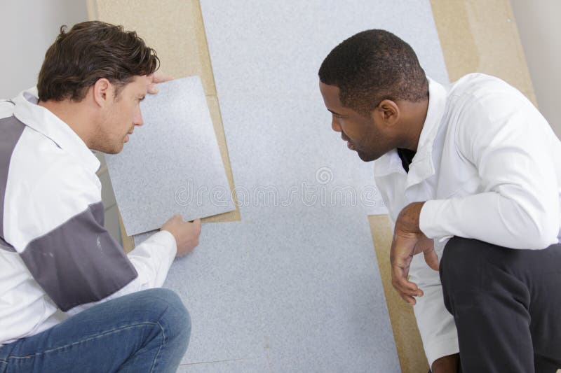 Two Workers Checking Something on Wall Stock Photo - Image of teamwork ...