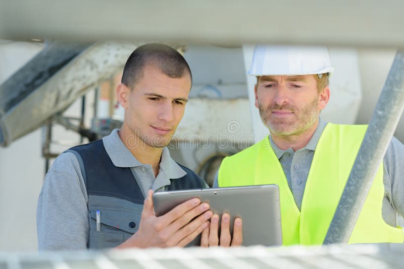 Two Workers Checking Tablet Stock Image - Image of eager, finance ...