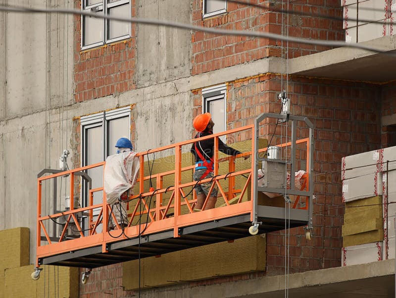 Two Workers in a Construction Basket Insulate the Glassy Wall of a ...