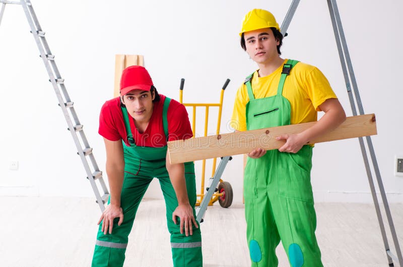 The Two Workers Contractors Working Indoors Stock Image - Image of ...