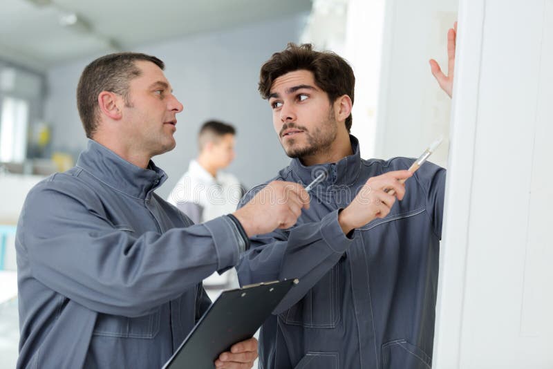 Two Workers Controlling Building On Construction Site Stock Photo ...