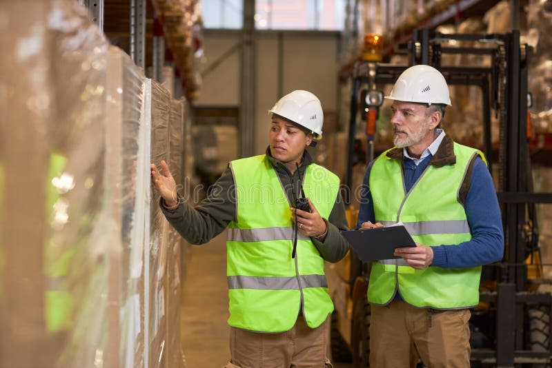 Two Workers Doing Inspection at Warehouse an Stock Photo - Image of ...