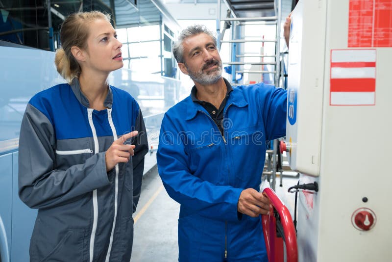 Two Workers Doing Maintenance on Machine Stock Image - Image of ...
