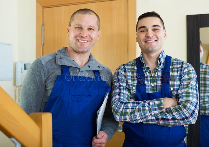 Two workers at doorstep stock image. Image of house, inventory - 63737841
