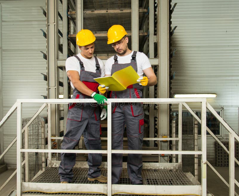 Two workers on a factory stock photo. Image of control - 39967488