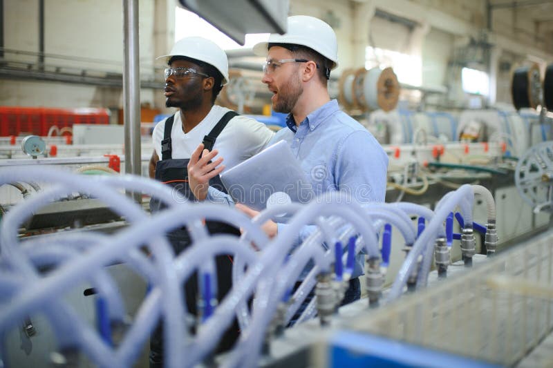 Two Workers at a Factory for the Production of Plastic Windows ...