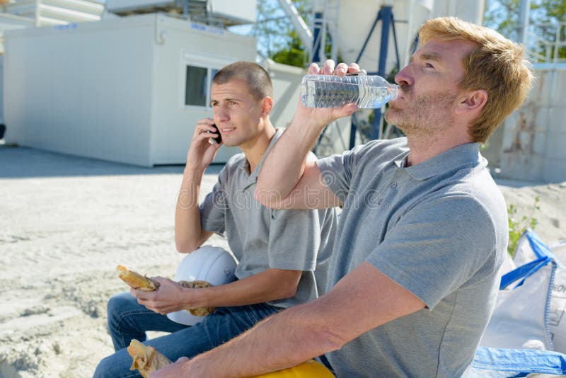 Two Workers Having Lunch Break Stock Photo - Image of drink, builders ...