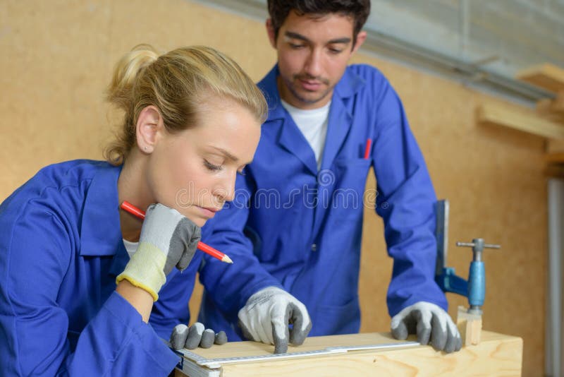Two Workers Helping Fellow Apprentice Stock Photo - Image of lesson ...