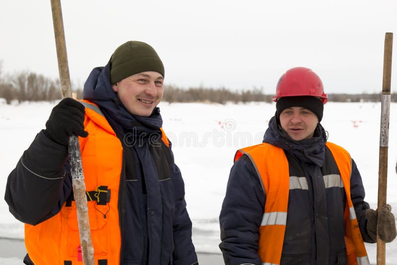 Two Workers on the Ice of a Frozen Pond Stock Photo - Image of people ...