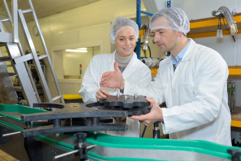 Two Workers in Lab Coats in Dairy Production Process Stock Photo ...