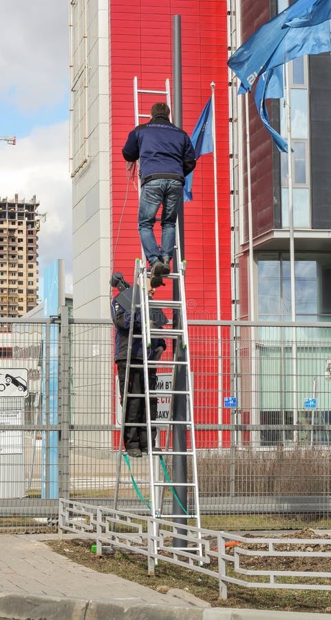 Two workers on the ladder. editorial photography. Image of work - 74223427