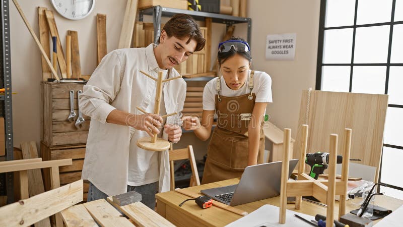 Two Workers, a Man and a Woman, Collaborate in a Workshop with ... Two Workers, a Man and a Woman, Collaborate in a Workshop with ...
