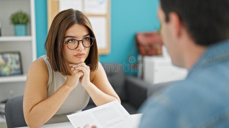 Two Workers Man and Woman Reading Document Sitting on Table at the ...